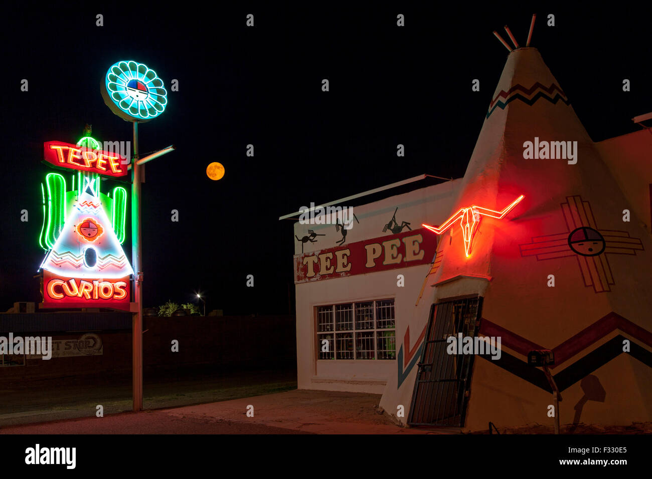 Full moon rises alongside the Tepee Curios neon sign along Route 66 in ...