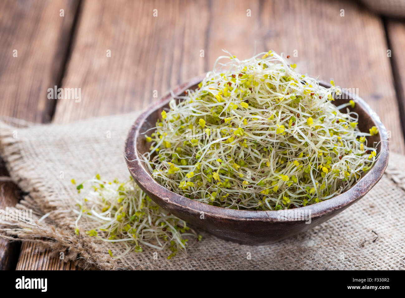 Fresh Broccoli Sprouts (detailed close-up shot) on vintage wooden ...