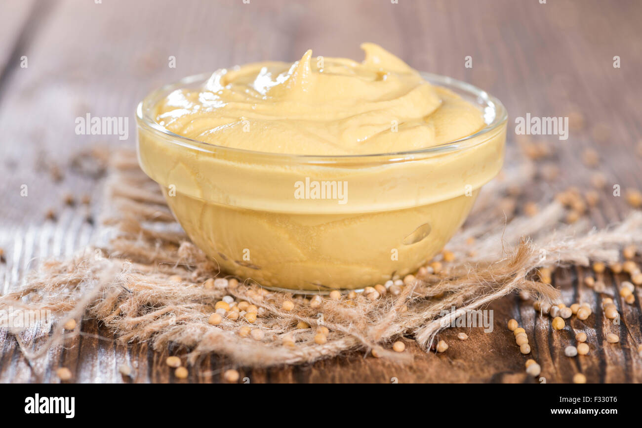 Portion of Mustard in a small bowl on wooden background Stock Photo - Alamy