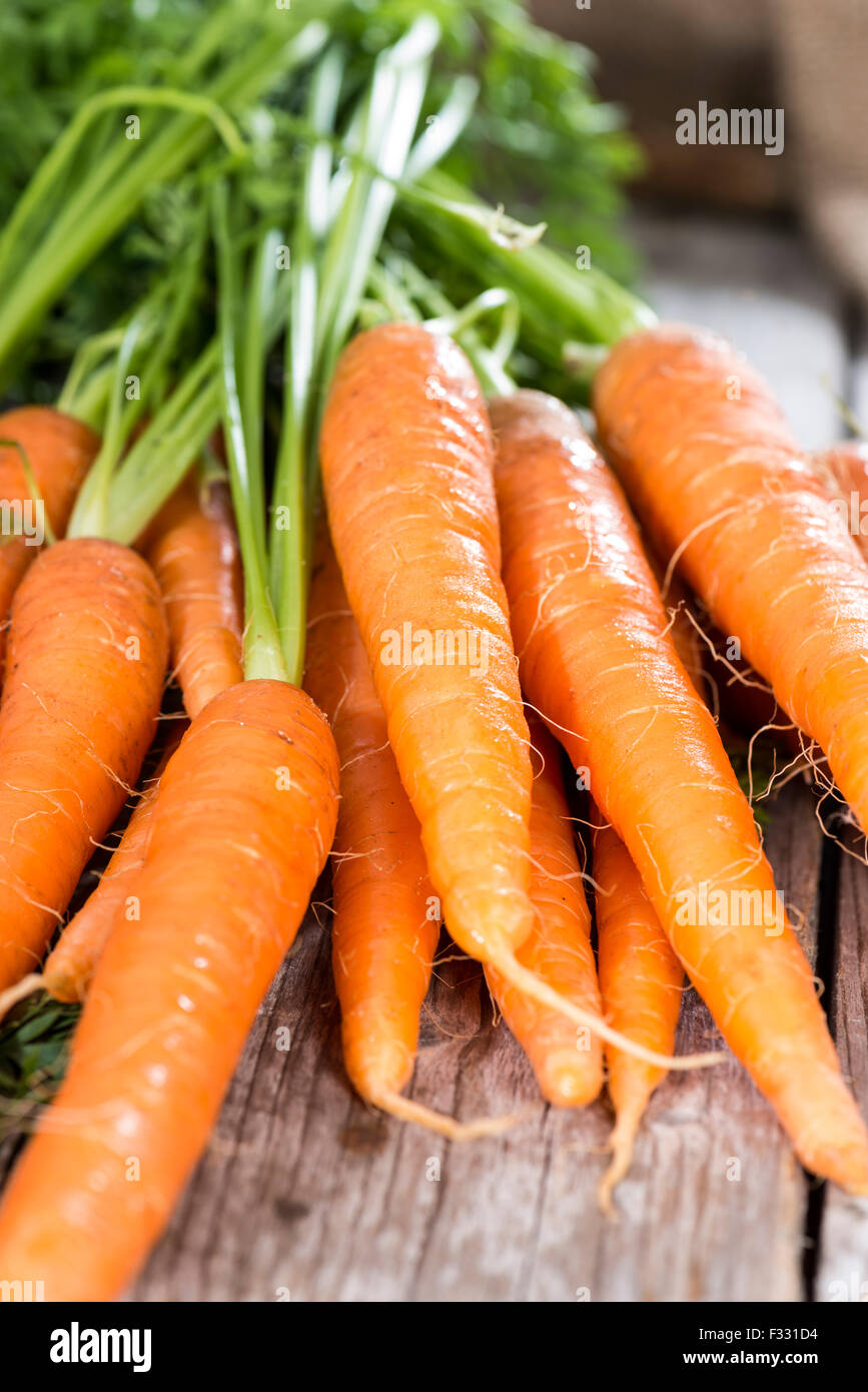 Some fresh Carrots on wooden background (close-up shot Stock Photo - Alamy