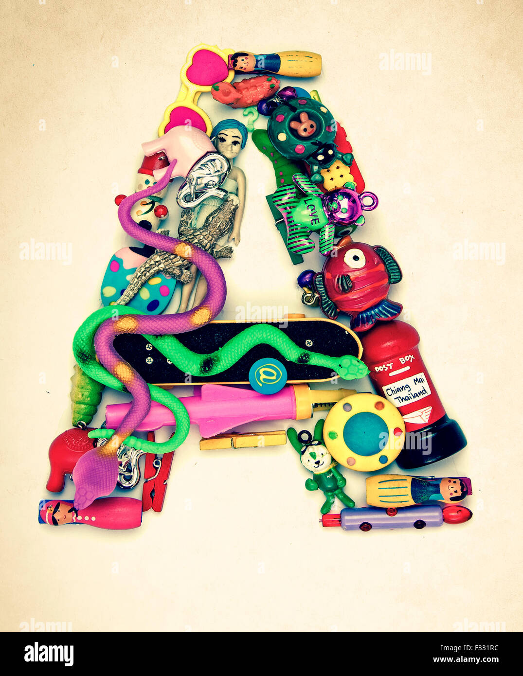 the letter A made from small toys Stock Photo - Alamy