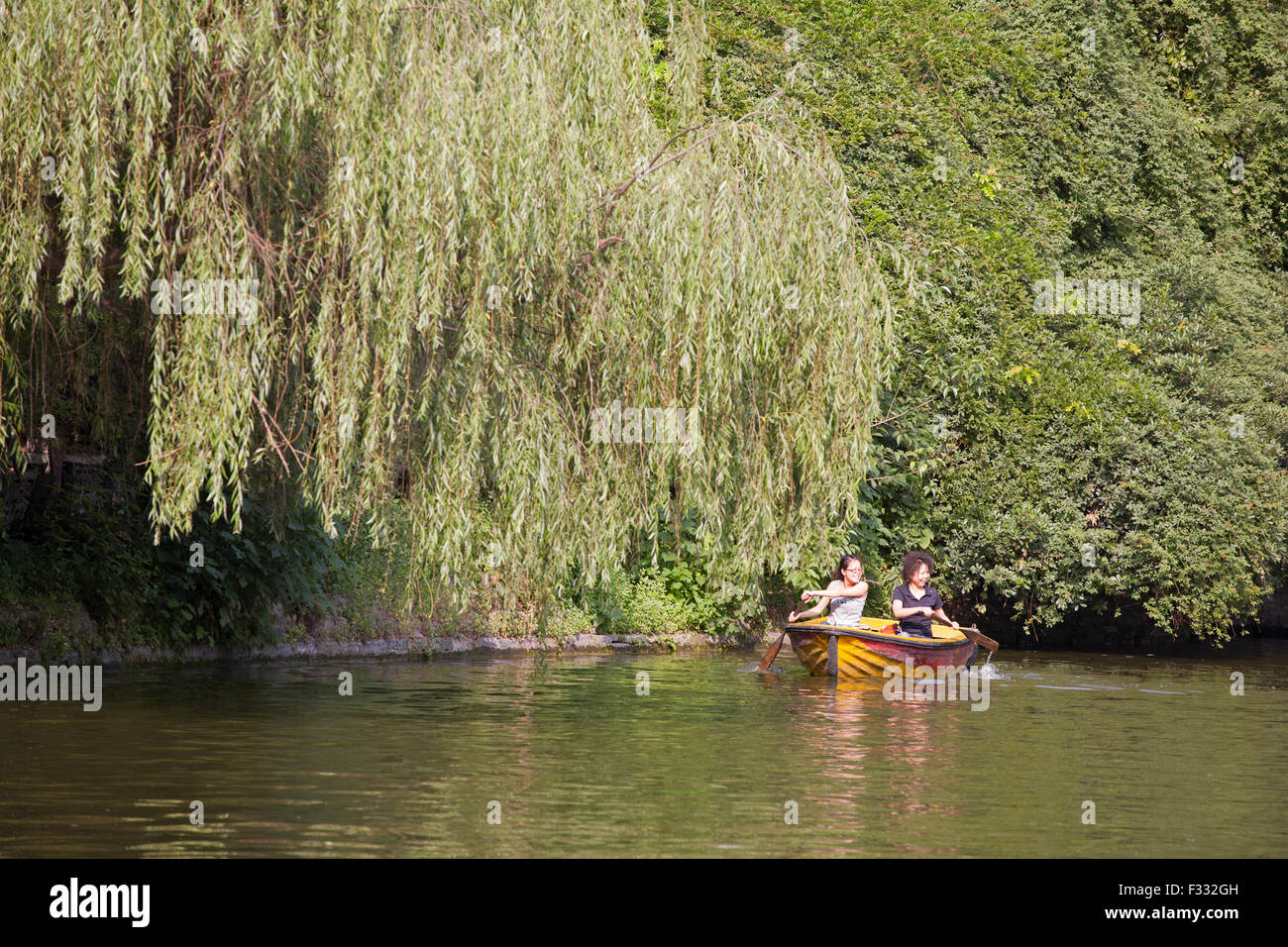 Two women rowing in a rowboat in Chengdu People's Park, Sichuan ...