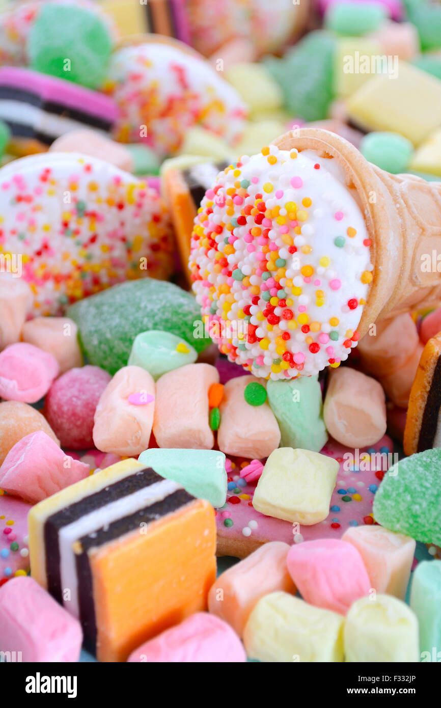 Bright colorful candy on pale blue wood table closeup Stock Photo - Alamy