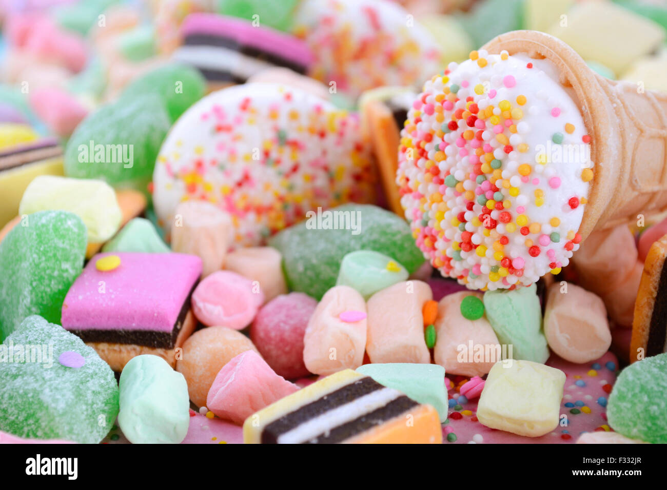 Bright colorful candy on pale blue wood table closeup Stock Photo - Alamy