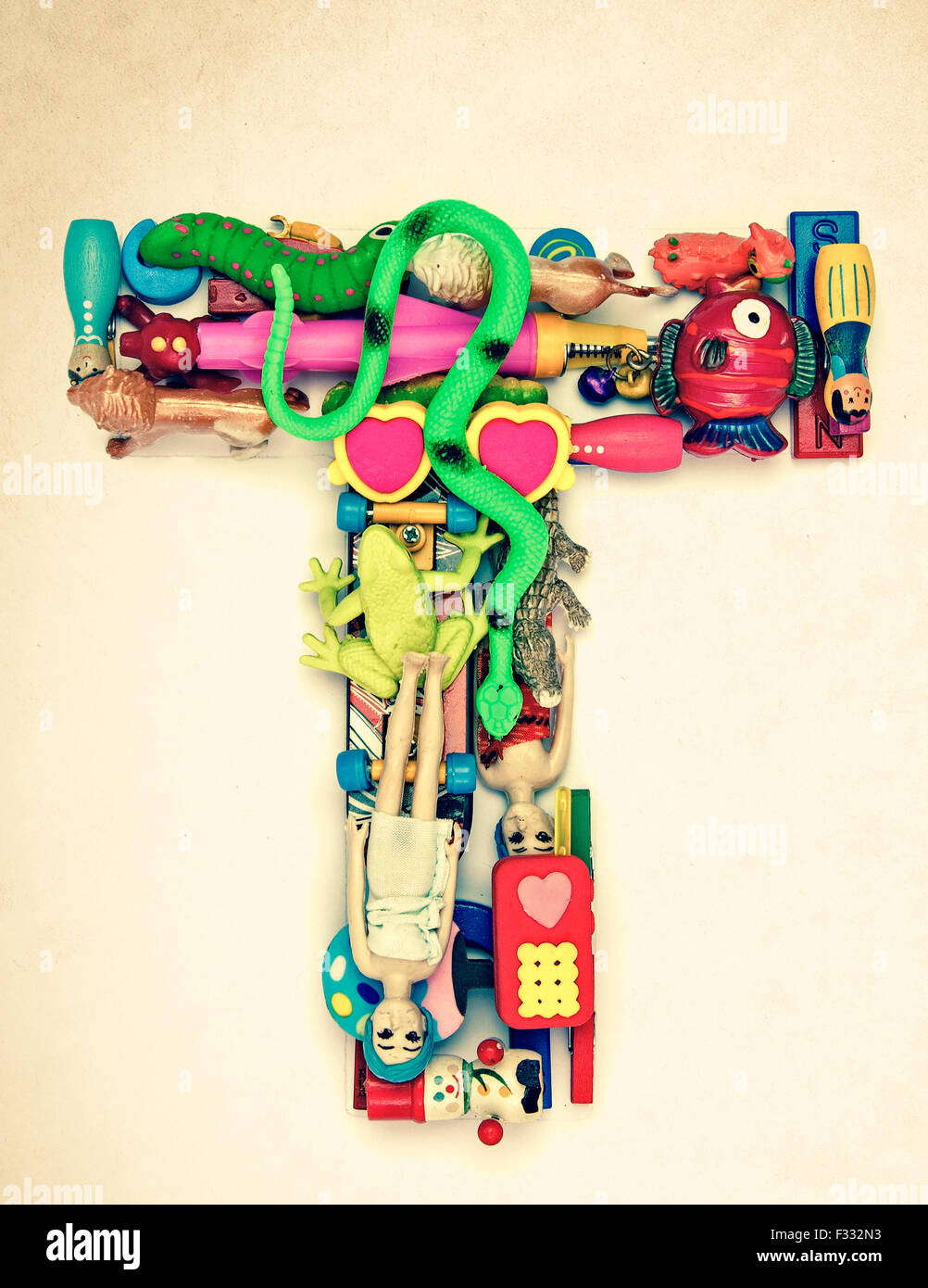 the letter T made from small toys Stock Photo - Alamy