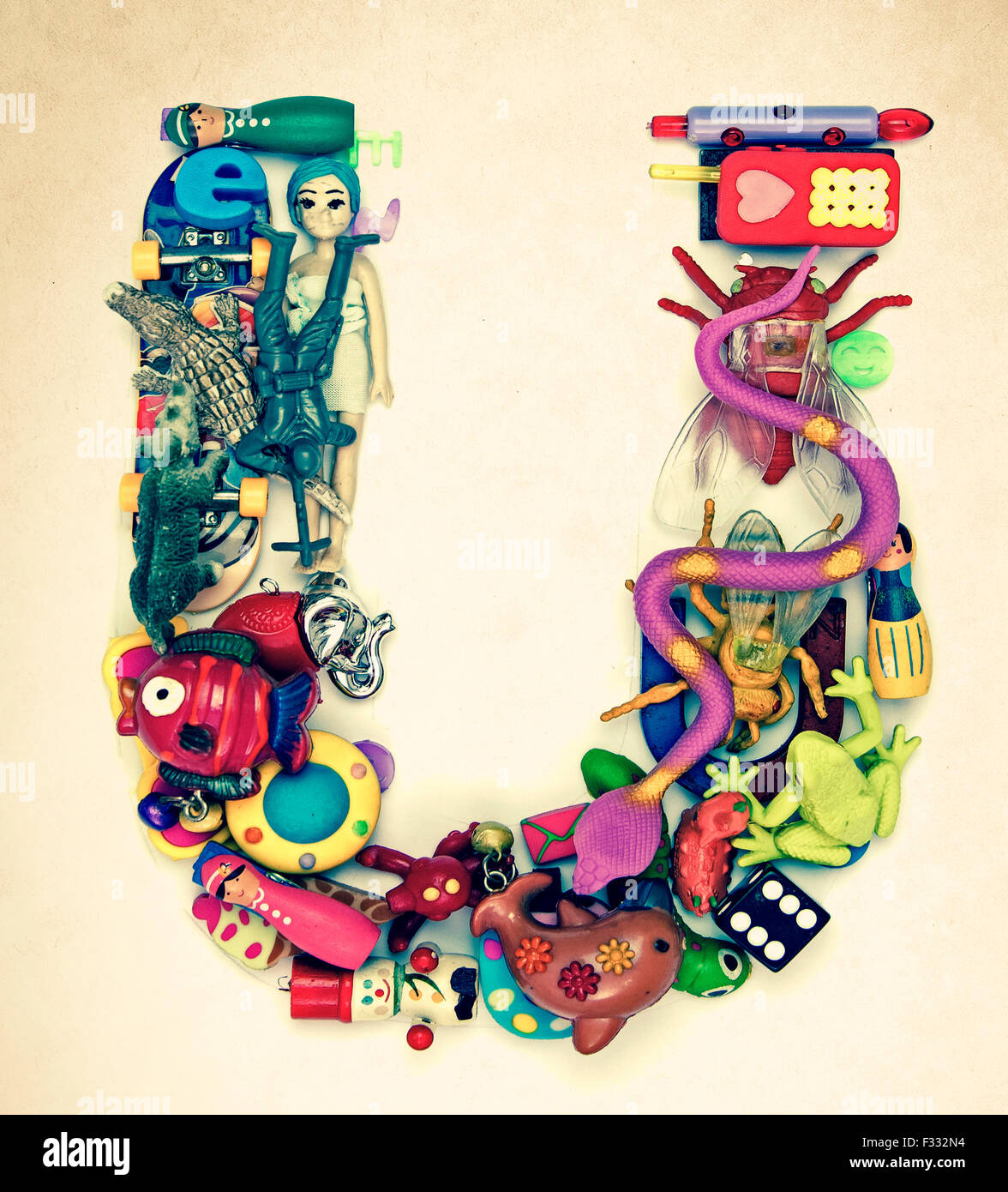 the letter U made from small toys Stock Photo - Alamy