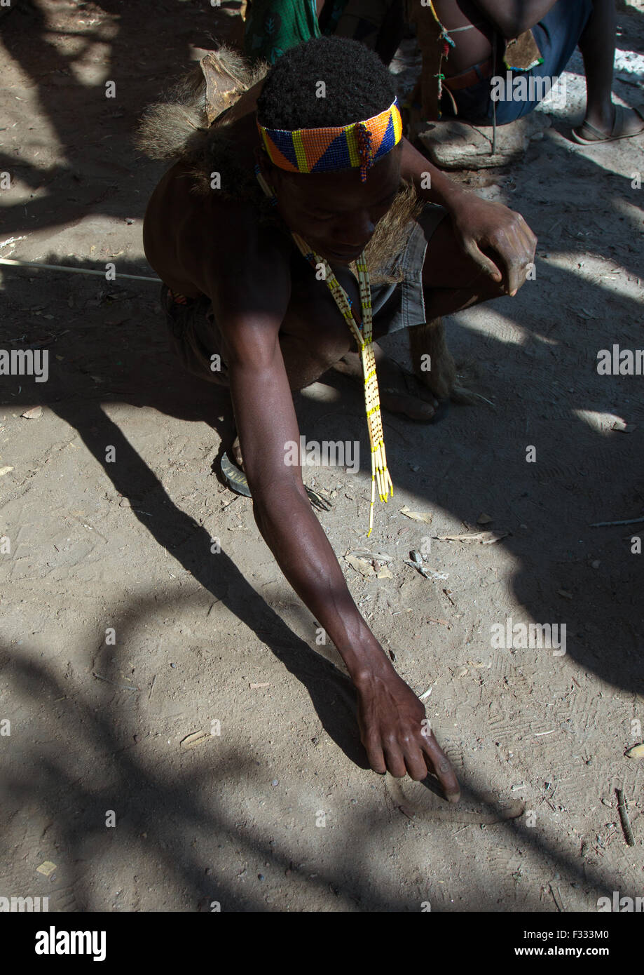 Tanzania, Serengeti Plateau, Lake Eyasi, hadzabe tribe man drawing a ...
