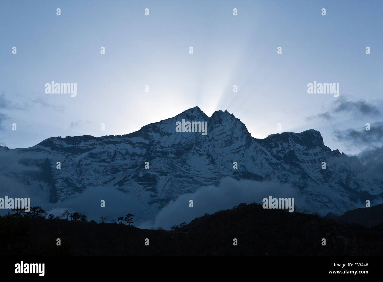 Sun rays over mountains in Himalaya Stock Photo - Alamy
