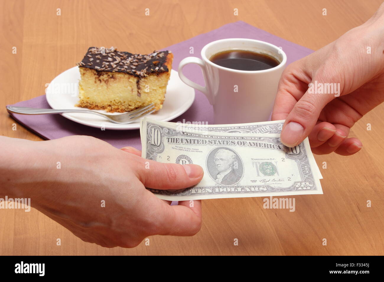 Paying for food in the cafe or restaurant, cheesecake and coffee ...