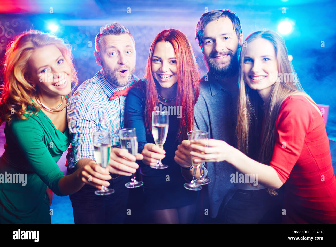 Group of ecstatic friends having party in night club Stock Photo - Alamy