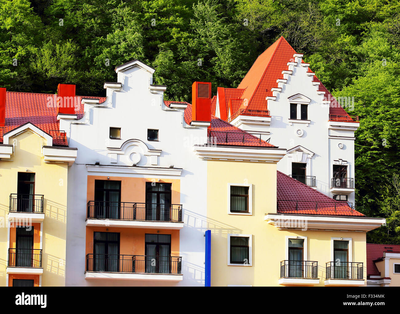 Facade of a massive building with a red roof and balconies Stock Photo ...