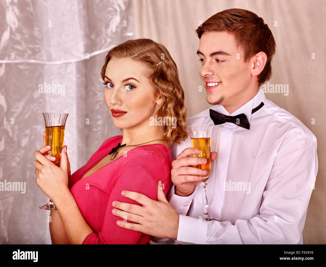 Couple on party drinking champagne Stock Photo - Alamy