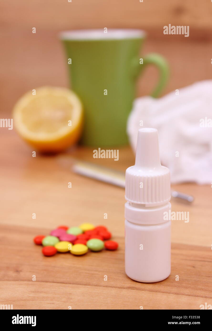 Pills and nose drops for colds, used handkerchiefs and hot tea with ...