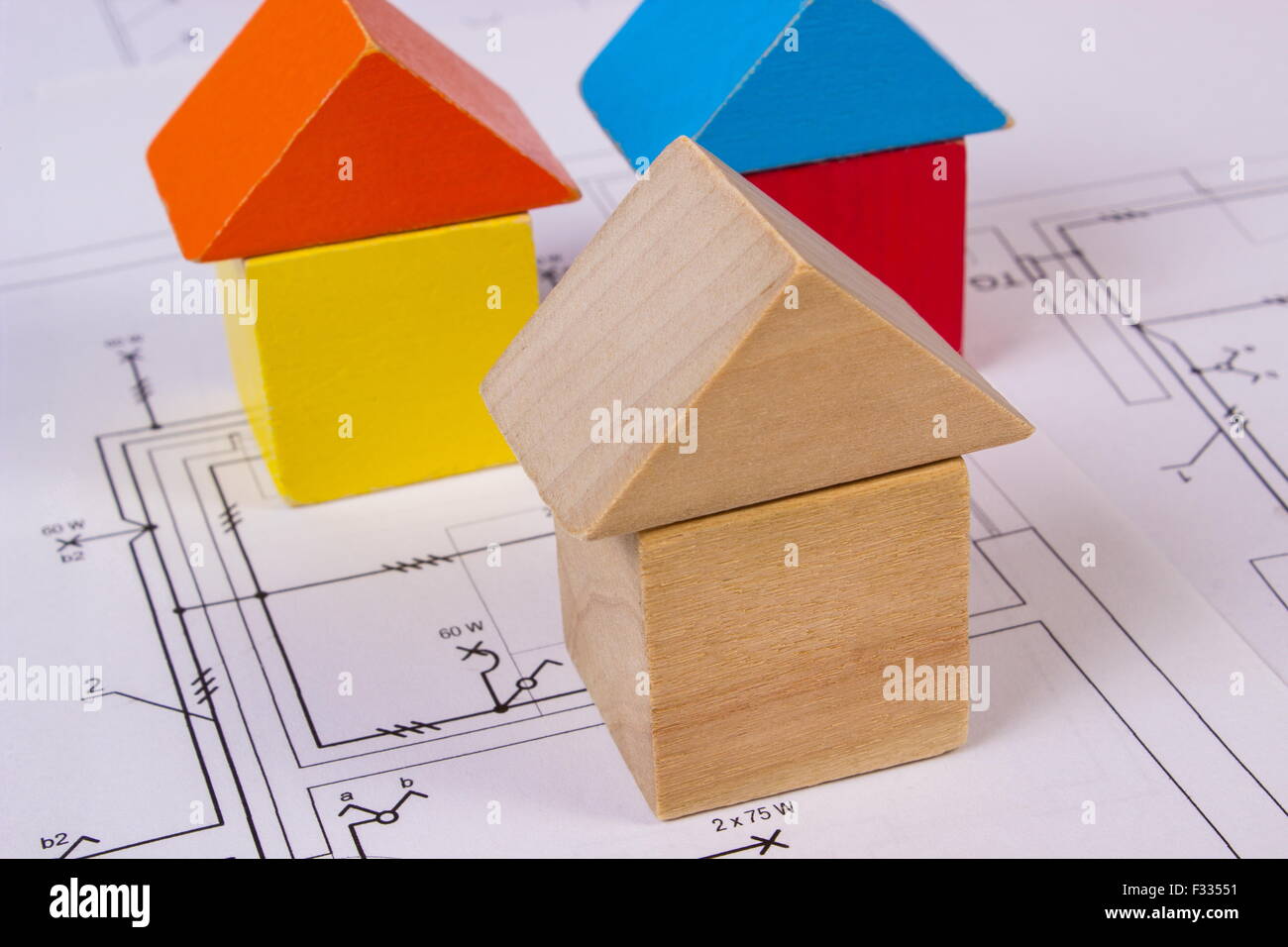 Houses shape made of wooden blocks lying on electrical construction ...