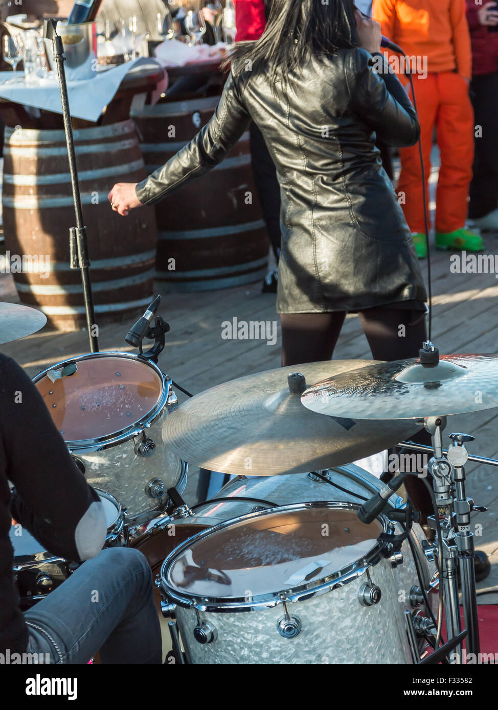 public music event: drums and woman singer rear view Stock Photo - Alamy
