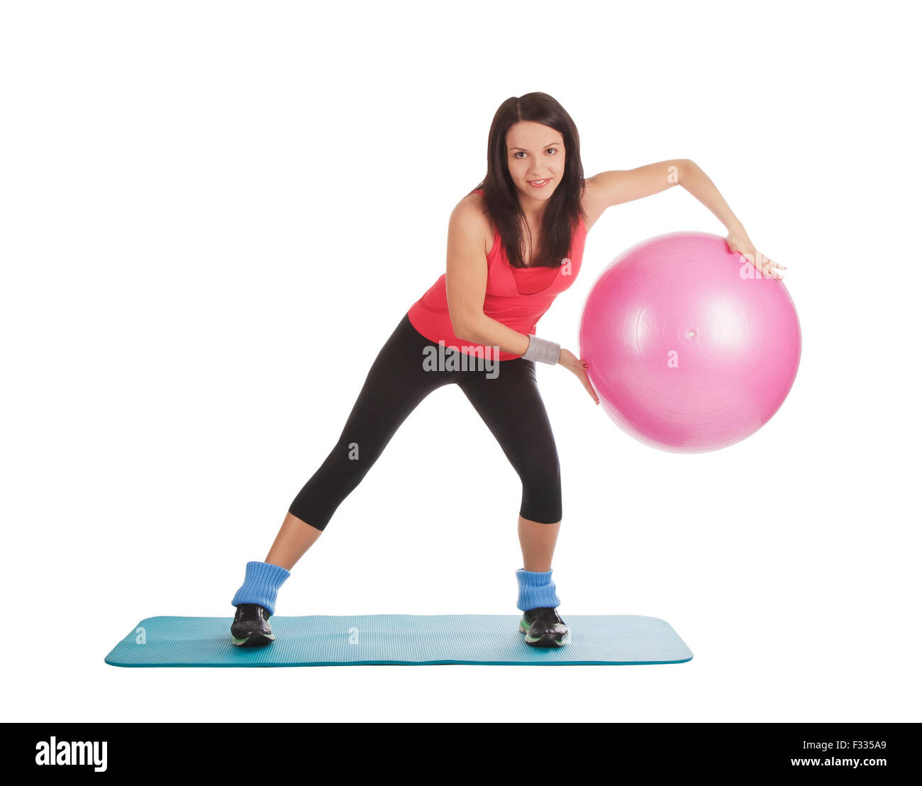 Attractive young female with fitness ball in stretching Stock Photo - Alamy
