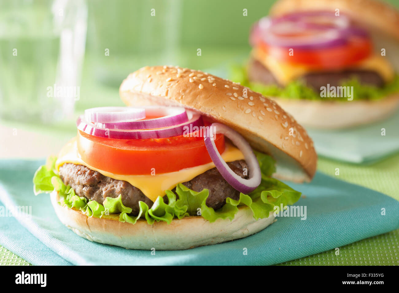 cheese burger with beef patty lettuce onion tomato Stock Photo - Alamy