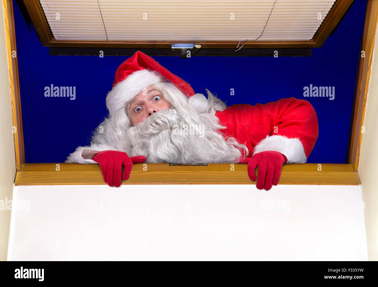 Santa Claus climbs into the room through an open window Stock Photo - Alamy