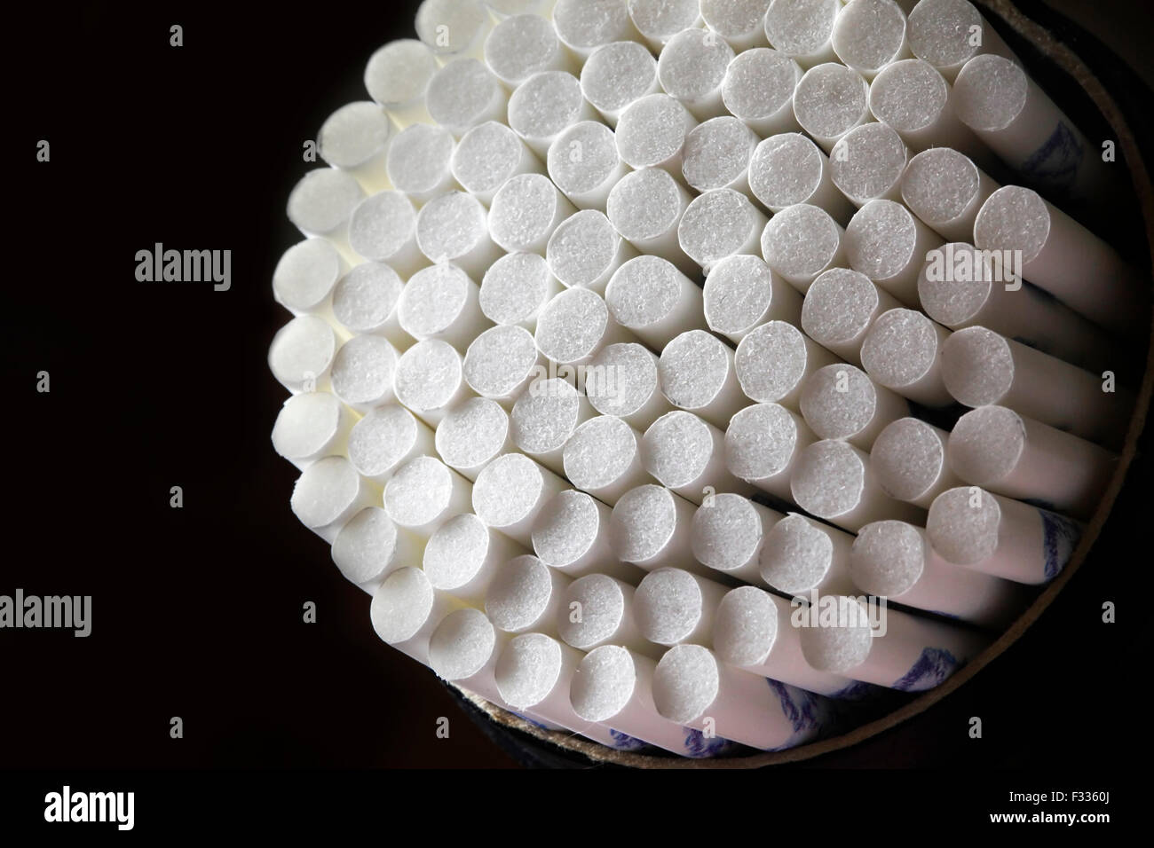 Filters of cigarettes in a round box close-up Stock Photo - Alamy