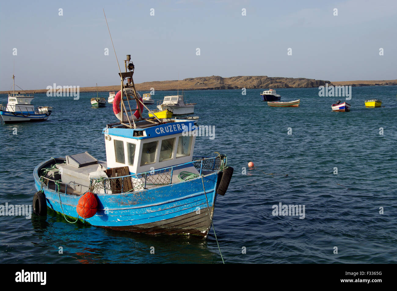 Blue tugboat in a oat harbour in Boa Vista on the island republic of ...
