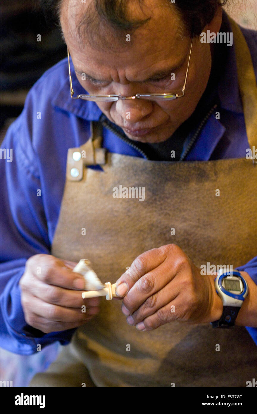 Artisan Adrian Villanueva Quisbert making a charango, a traditional ...