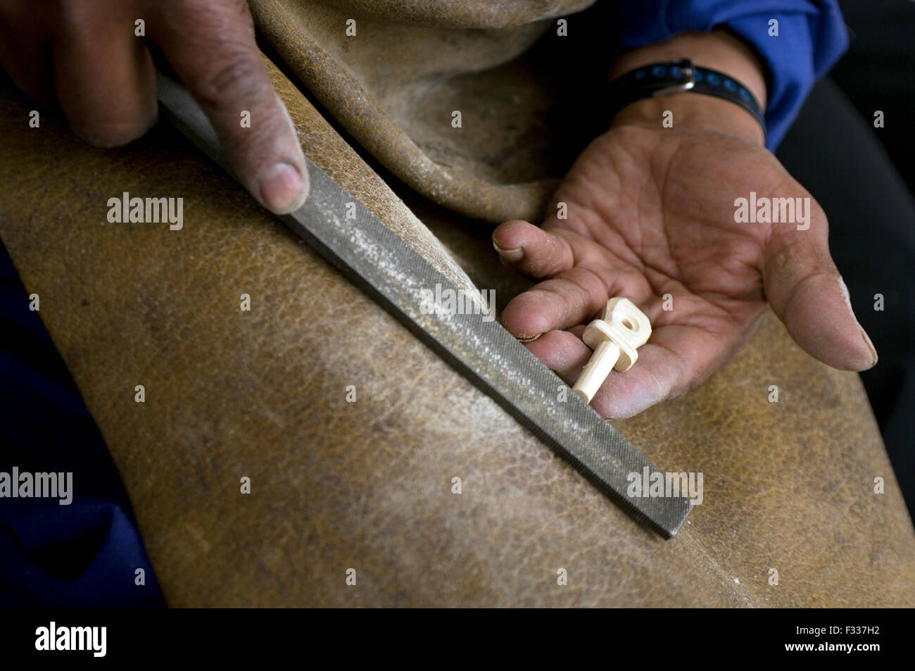 Aymara Bolivian man making a charango, a small stringed instrument in ...