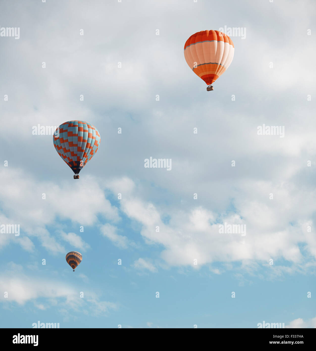 Three air balloons in blue sky. Vertical photo Stock Photo - Alamy
