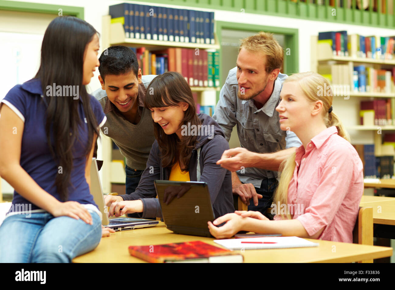Group of students learning in library at university Stock Photo - Alamy