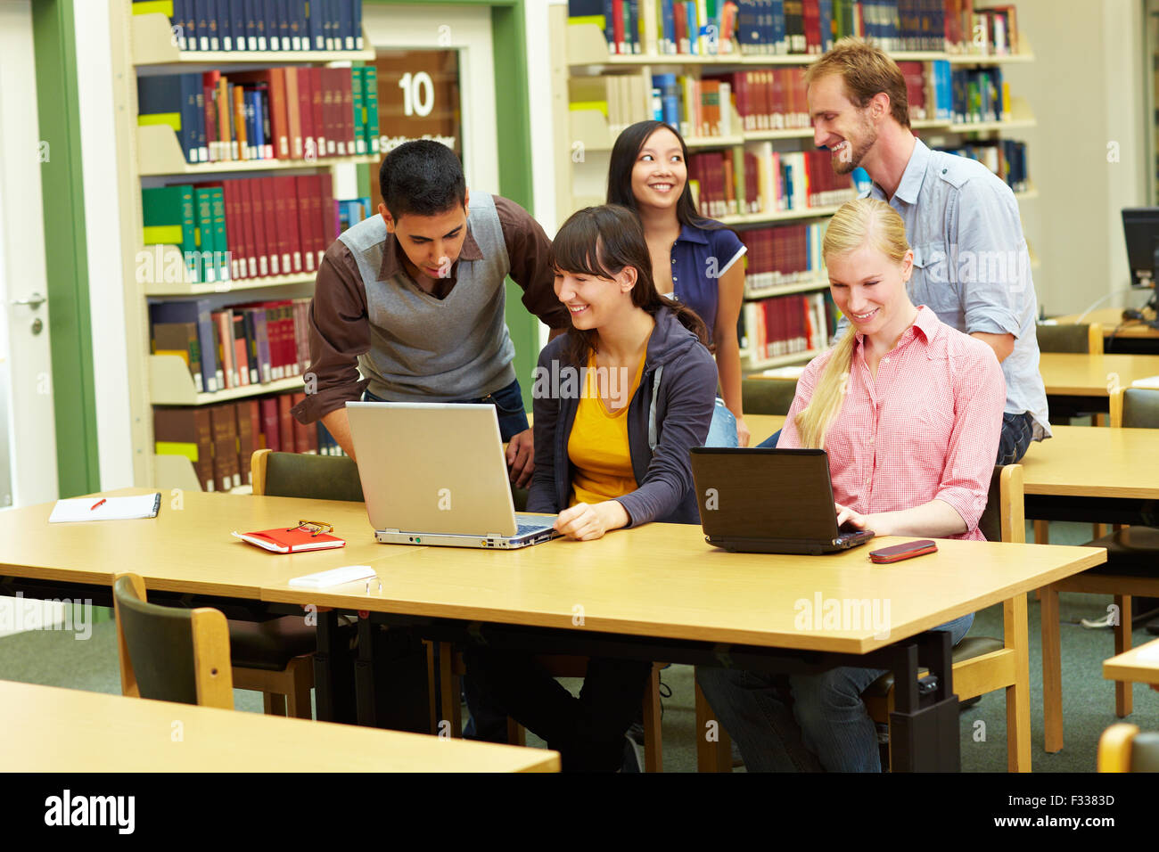 Group of students learning in library at university Stock Photo - Alamy