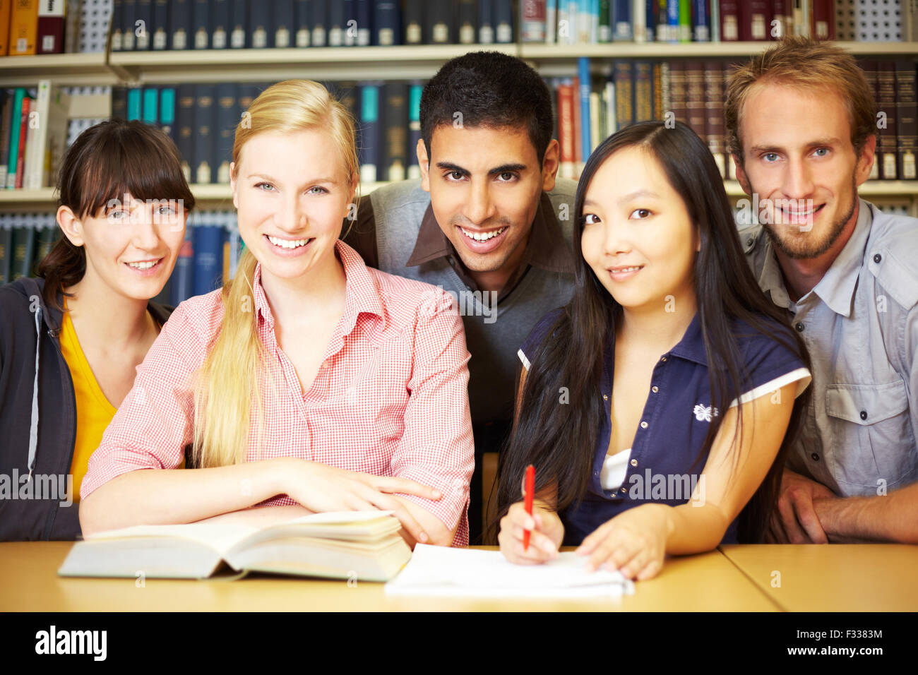 Group of students learning in library at university Stock Photo - Alamy