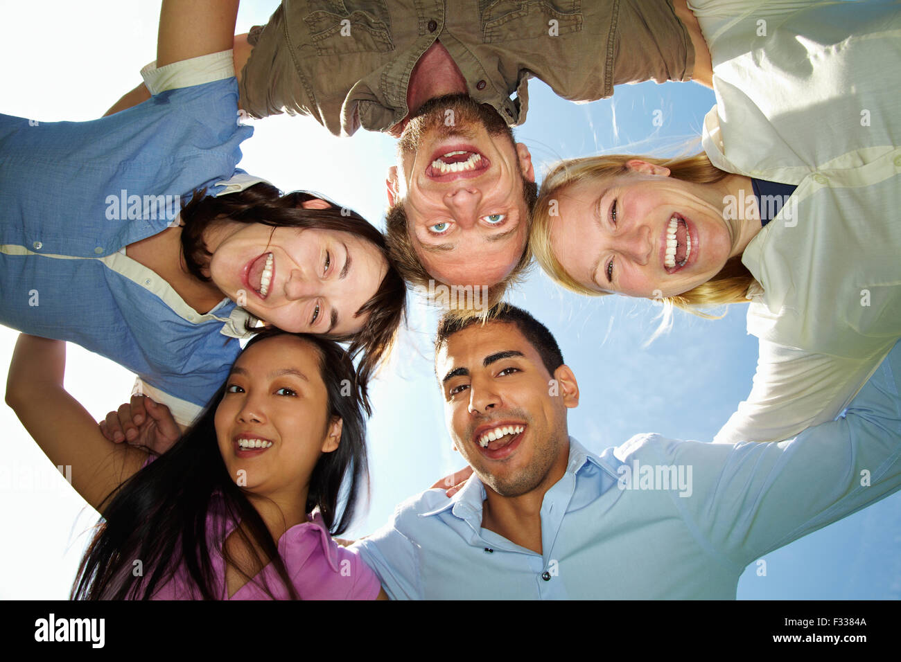 Five happy friends embracing under blue sky Stock Photo - Alamy