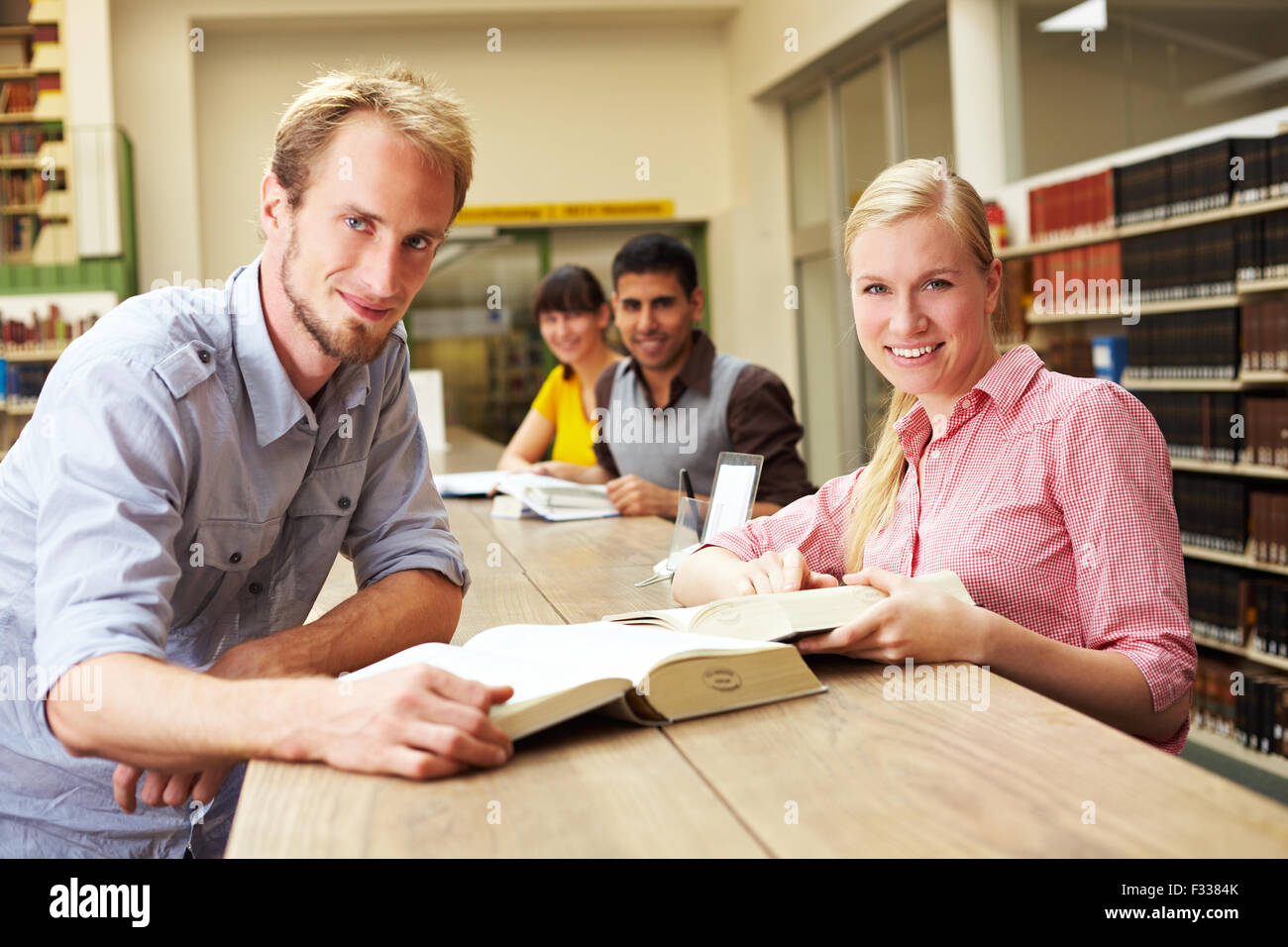 Group of students learning in library at university Stock Photo - Alamy