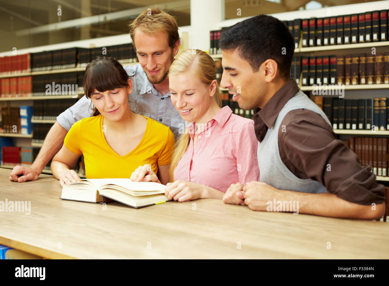 Group of students learning in library at university Stock Photo - Alamy