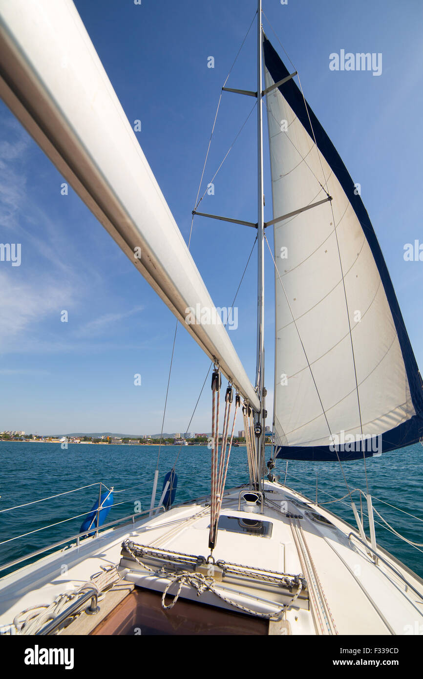 Yatch sail and desk on blue sky and sea background Stock Photo - Alamy