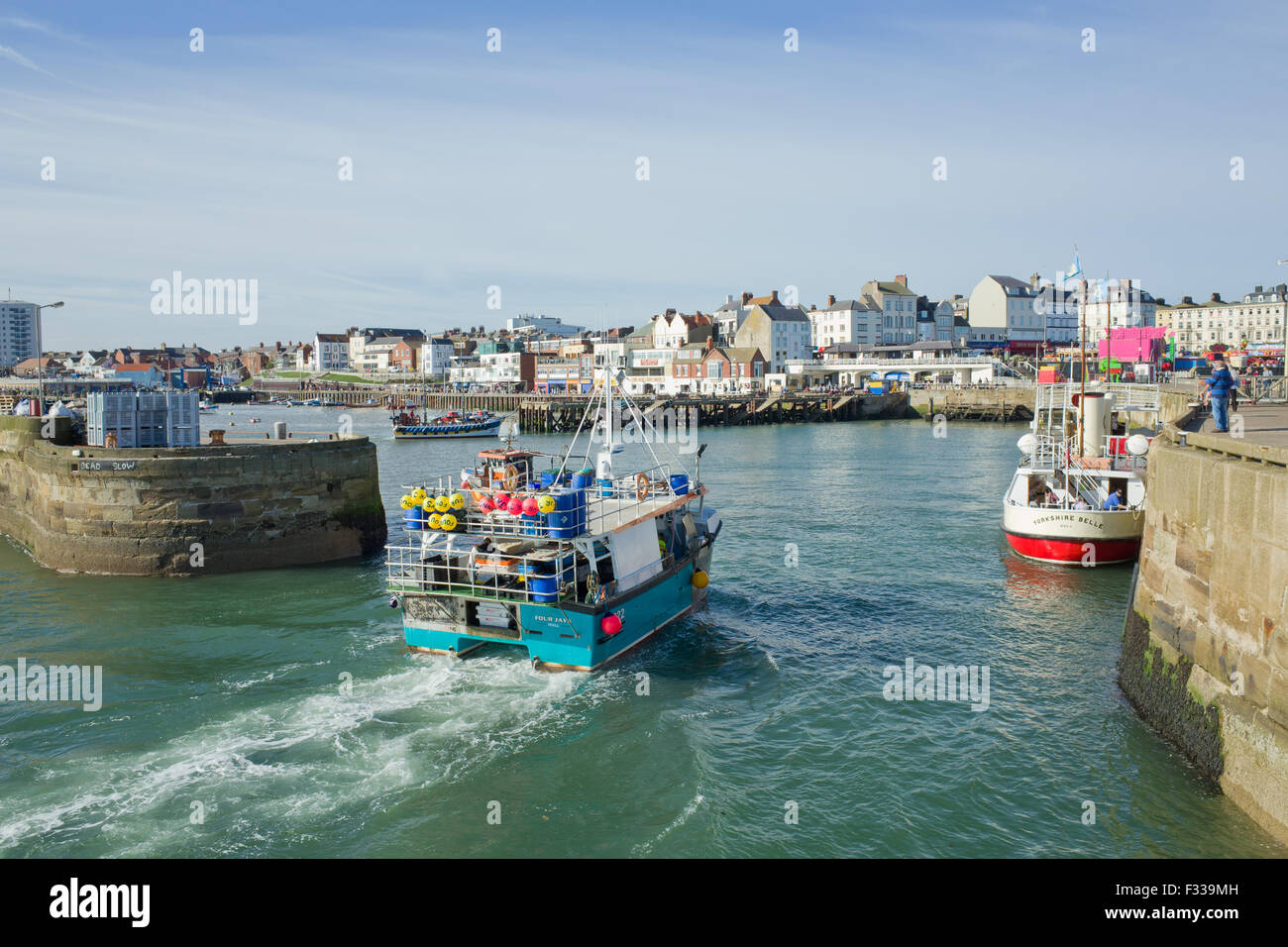 Fishing boat entering Bridlington harbour East Yorkshire UK Stock Photo ...