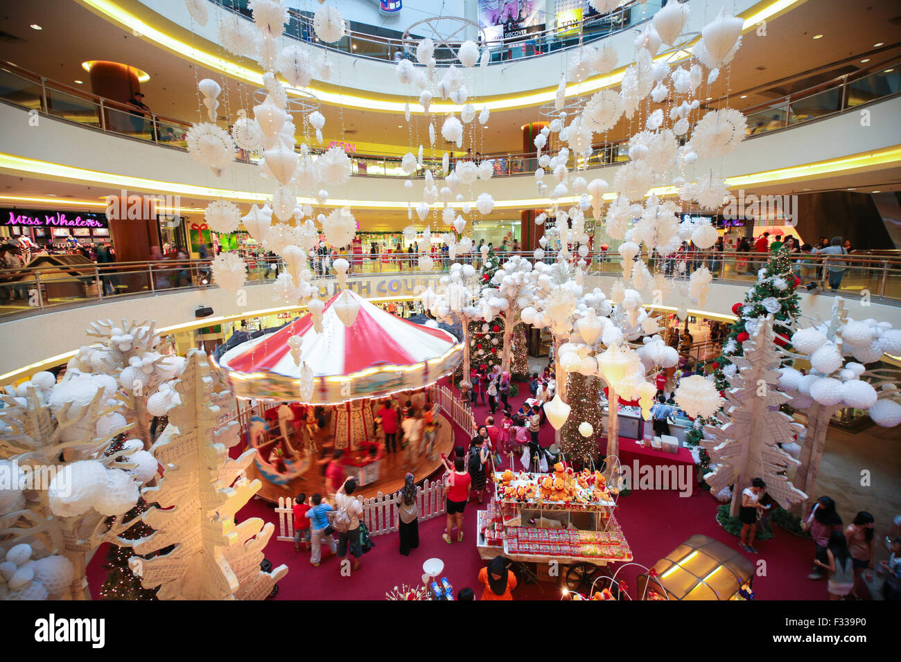 Parent and their children playing carousel at Mid Valley shopping mall ...