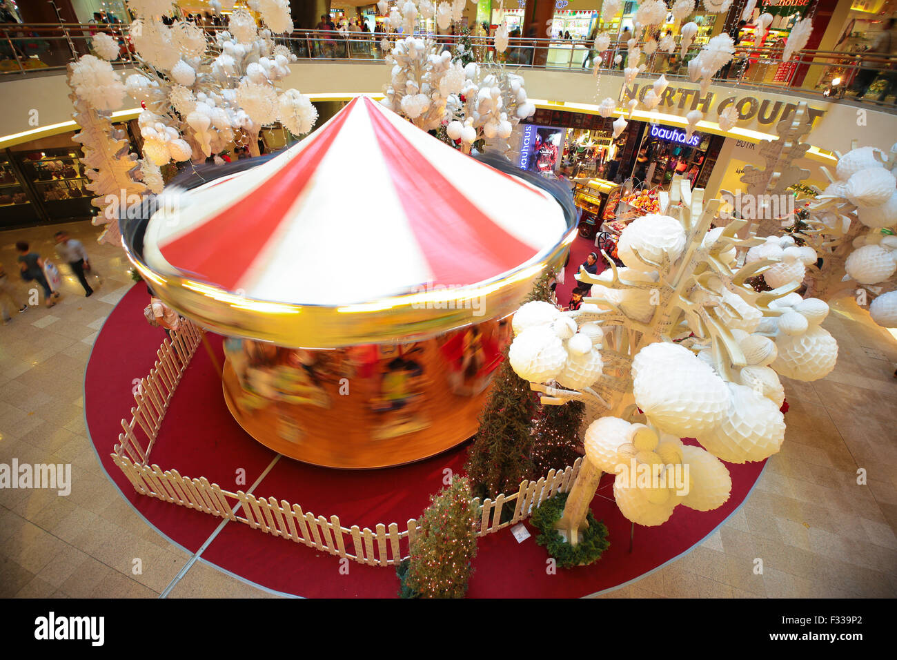 Parent and their children playing carousel at Mid Valley shopping mall ...