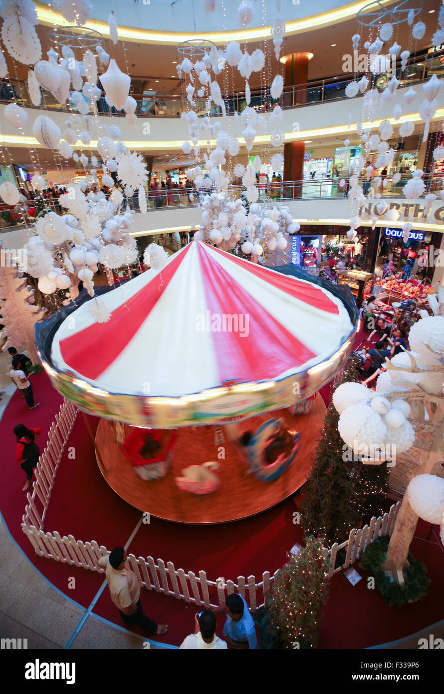 Parent and their children playing carousel at Mid Valley shopping mall ...