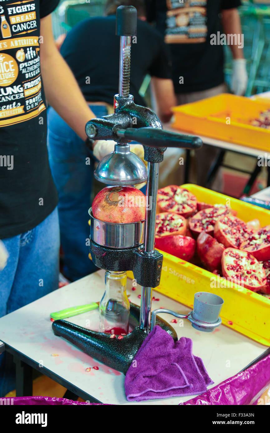 Pomegranate juice extracting Stock Photo - Alamy