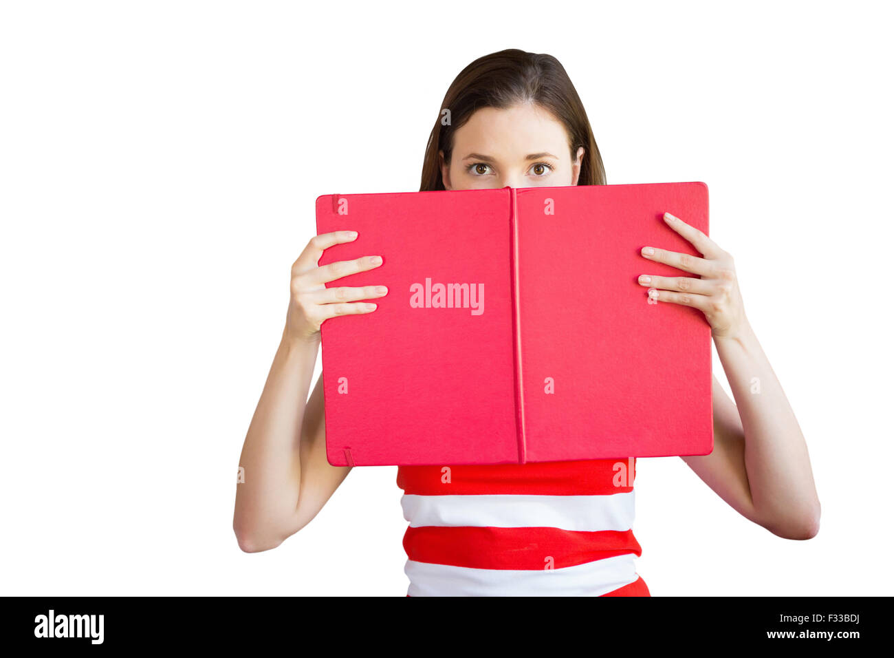 Composite image of student holding book over face Stock Photo - Alamy