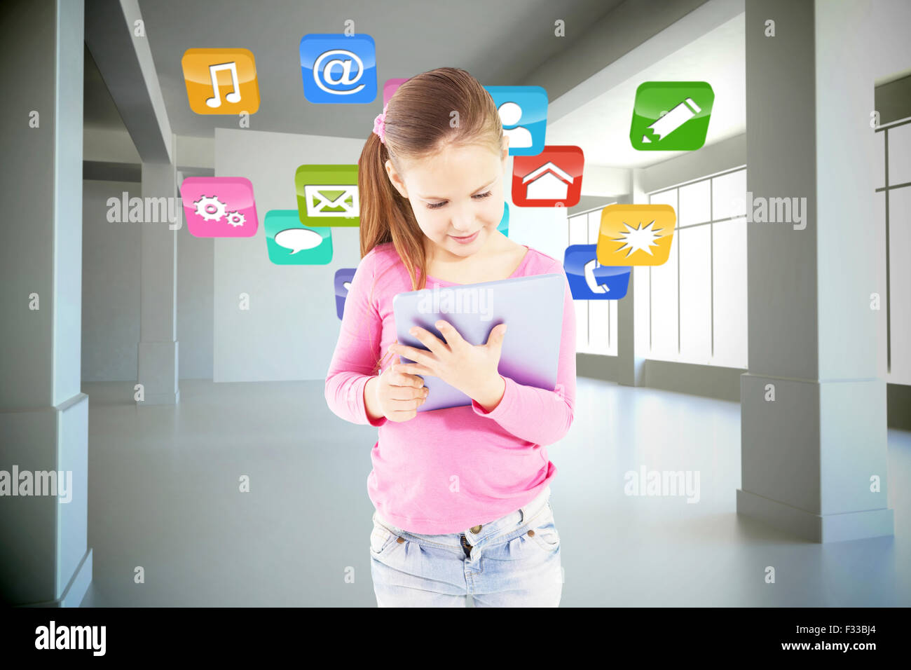 Composite image of cute girl using tablet Stock Photo - Alamy