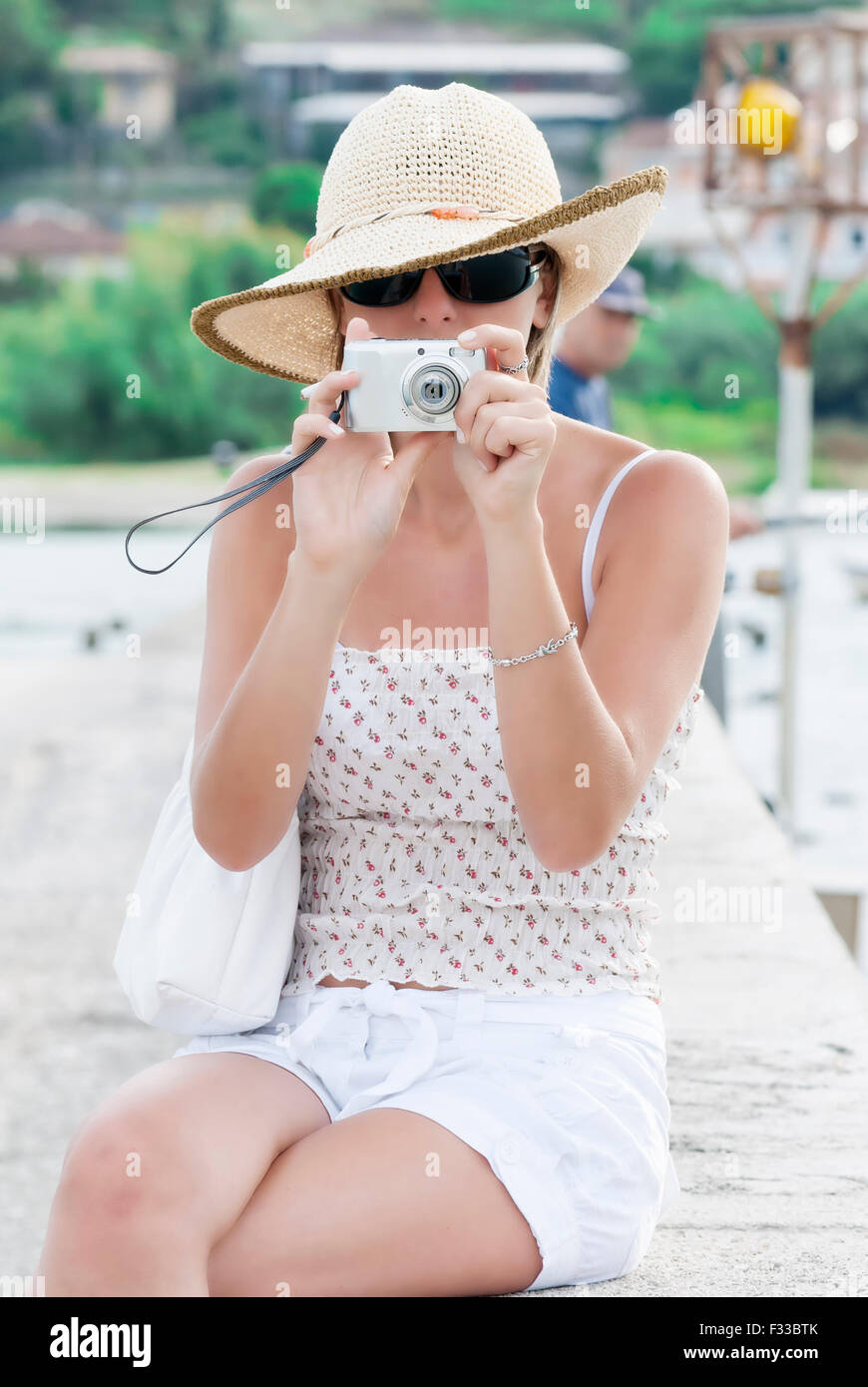 Young woman taking picture with a compact camera Stock Photo - Alamy