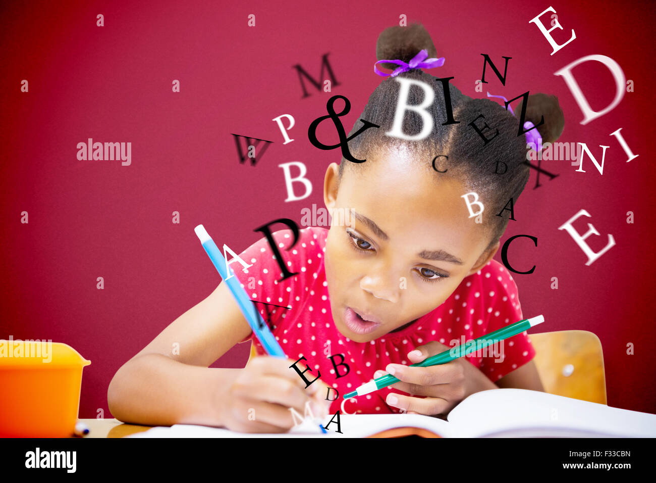Composite image of cute pupil writing at desk in classroom Stock Photo ...