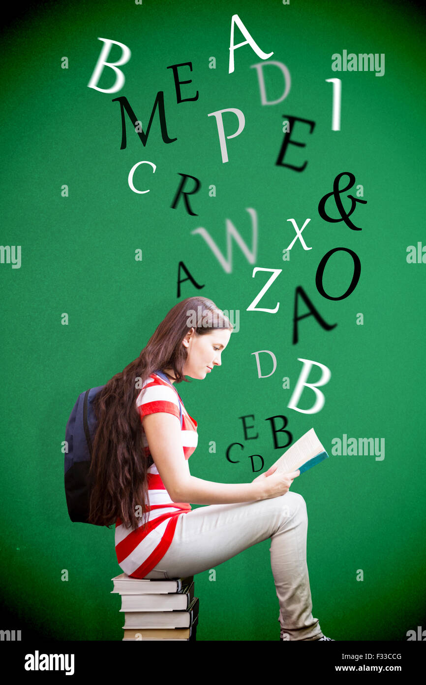 Composite image of student reading book in library Stock Photo - Alamy