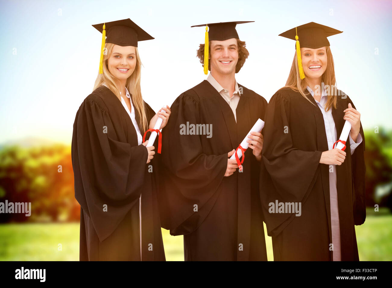Composite image of three smiling students in graduate robe holding a ...
