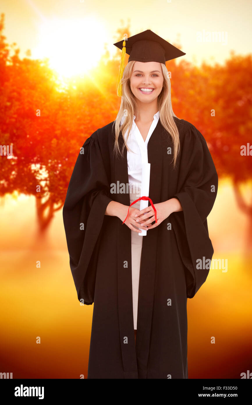 Composite image of smiling blonde student in graduate robe Stock Photo ...