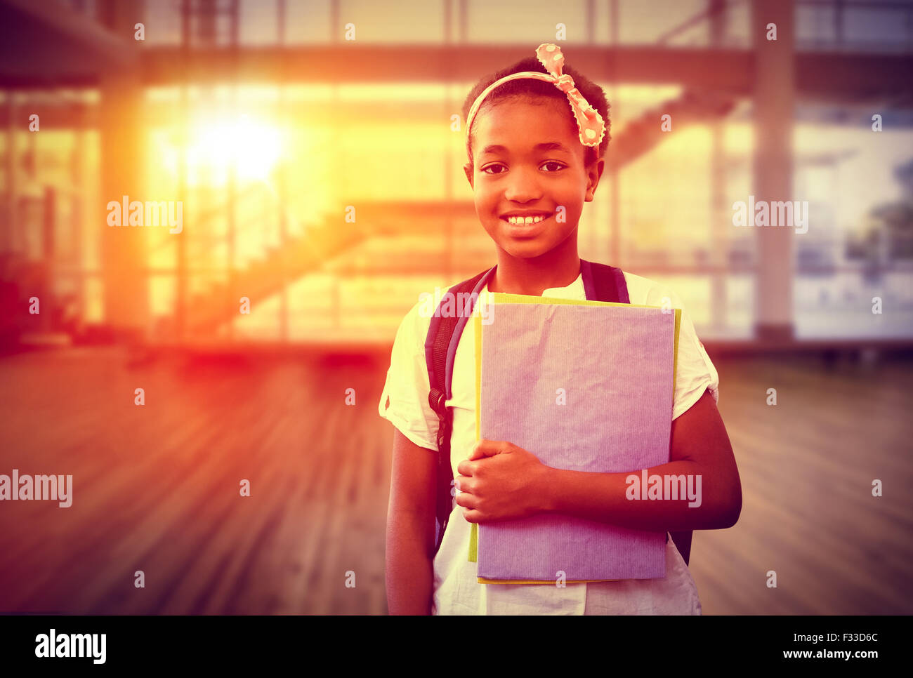 Composite image of little girl holding folders in school corridor Stock ...