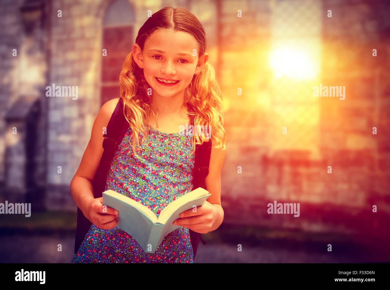 Composite image of cute little girl reading book in library Stock Photo ...
