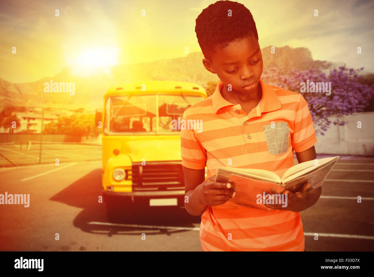 Composite image of cute boy reading book in library Stock Photo - Alamy