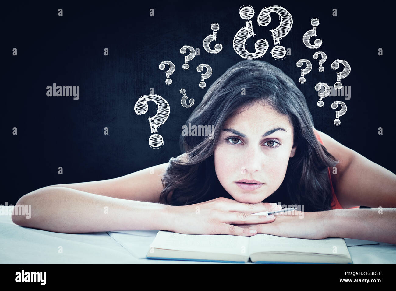 Composite image of frowning student head on her books Stock Photo - Alamy